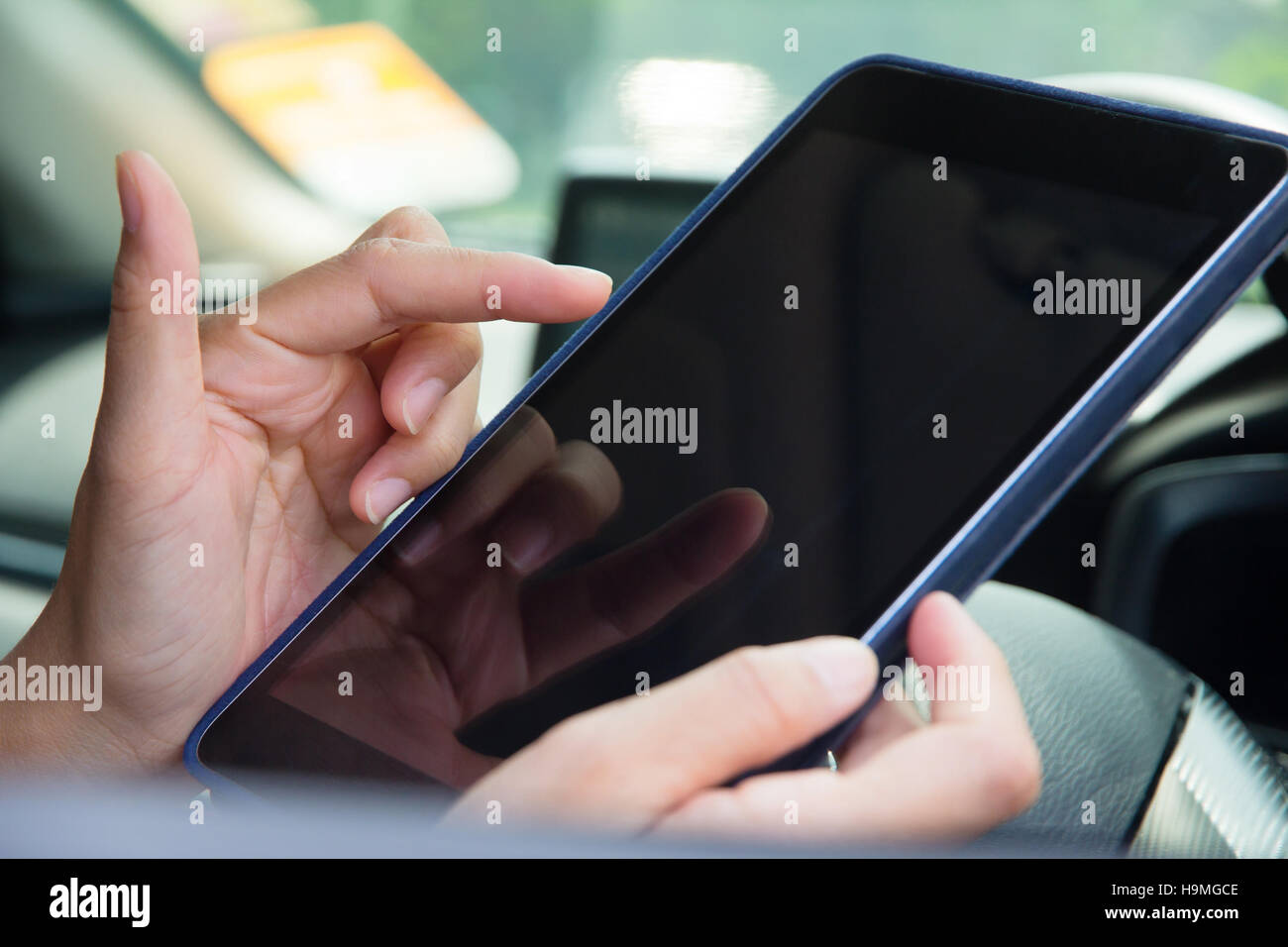 image of using a digital tablet inside of a car Stock Photo - Alamy