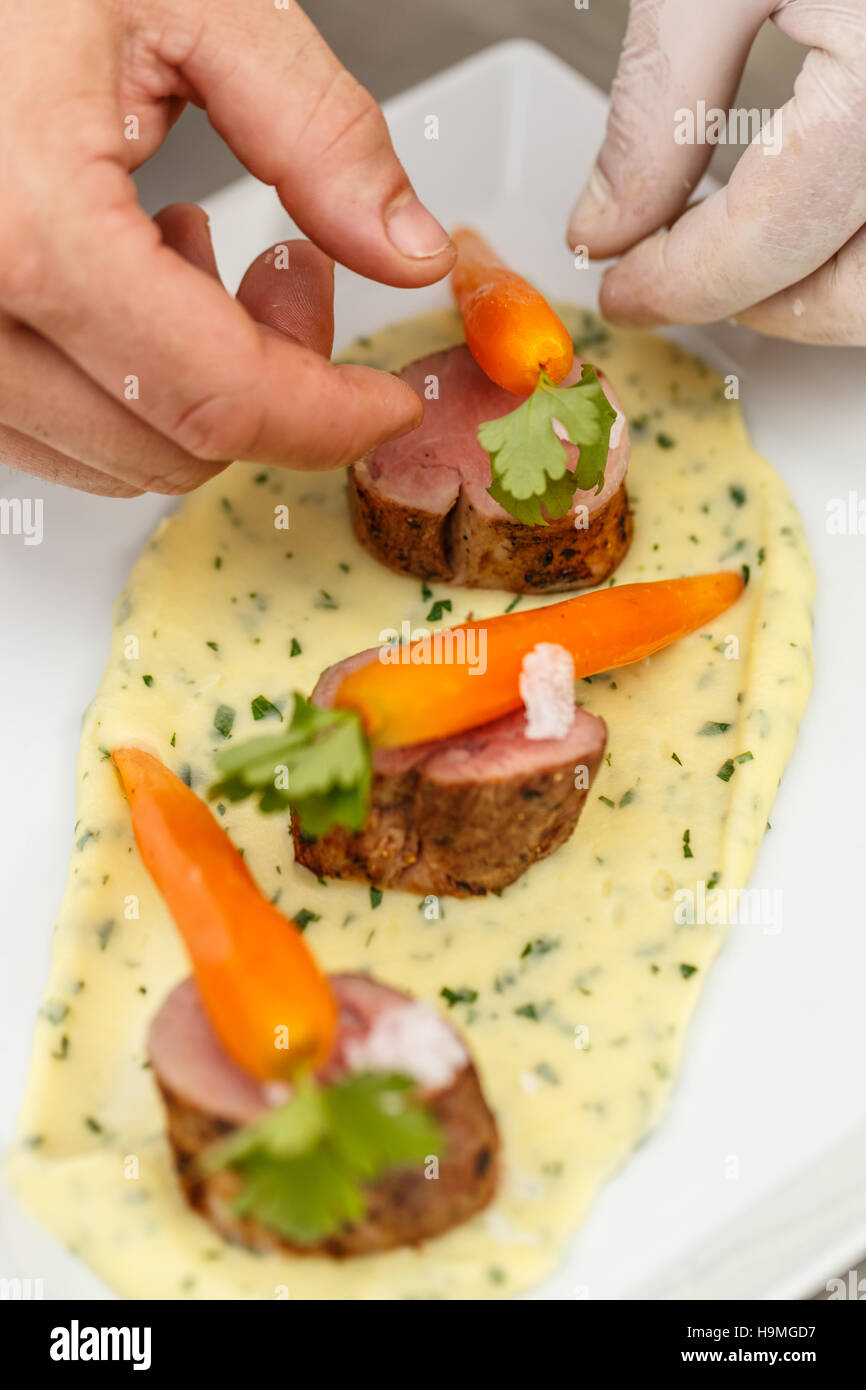 Chef decorating meat plate Stock Photo - Alamy