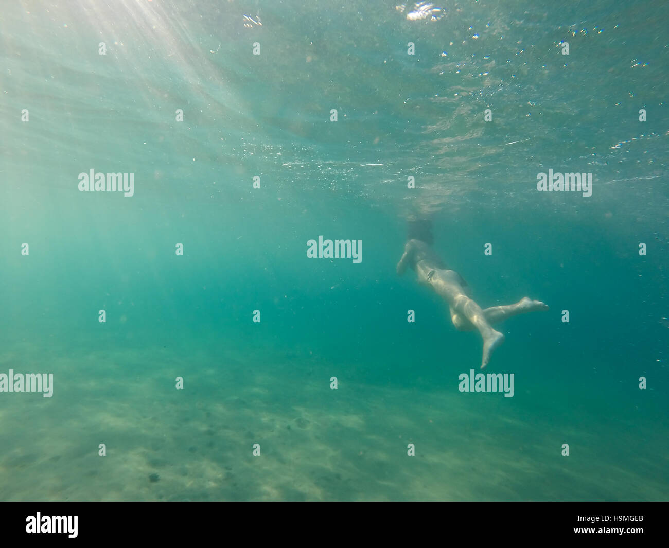 Woman dives in bikini Stock Photo - Alamy