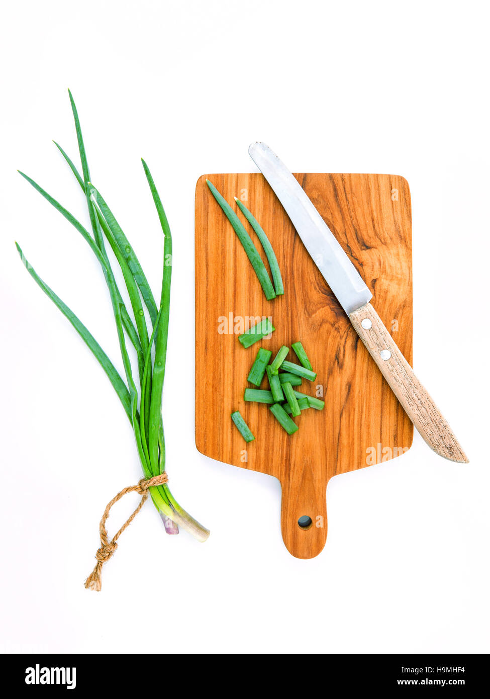 Branch of fresh spring onions and spring onions chops with cutti Stock ...