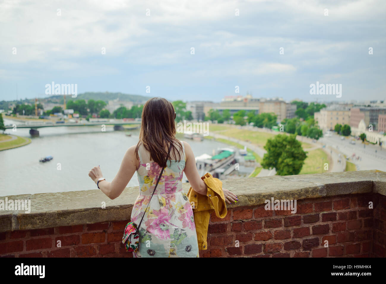 A stylish girl looking at the river Stock Photo - Alamy