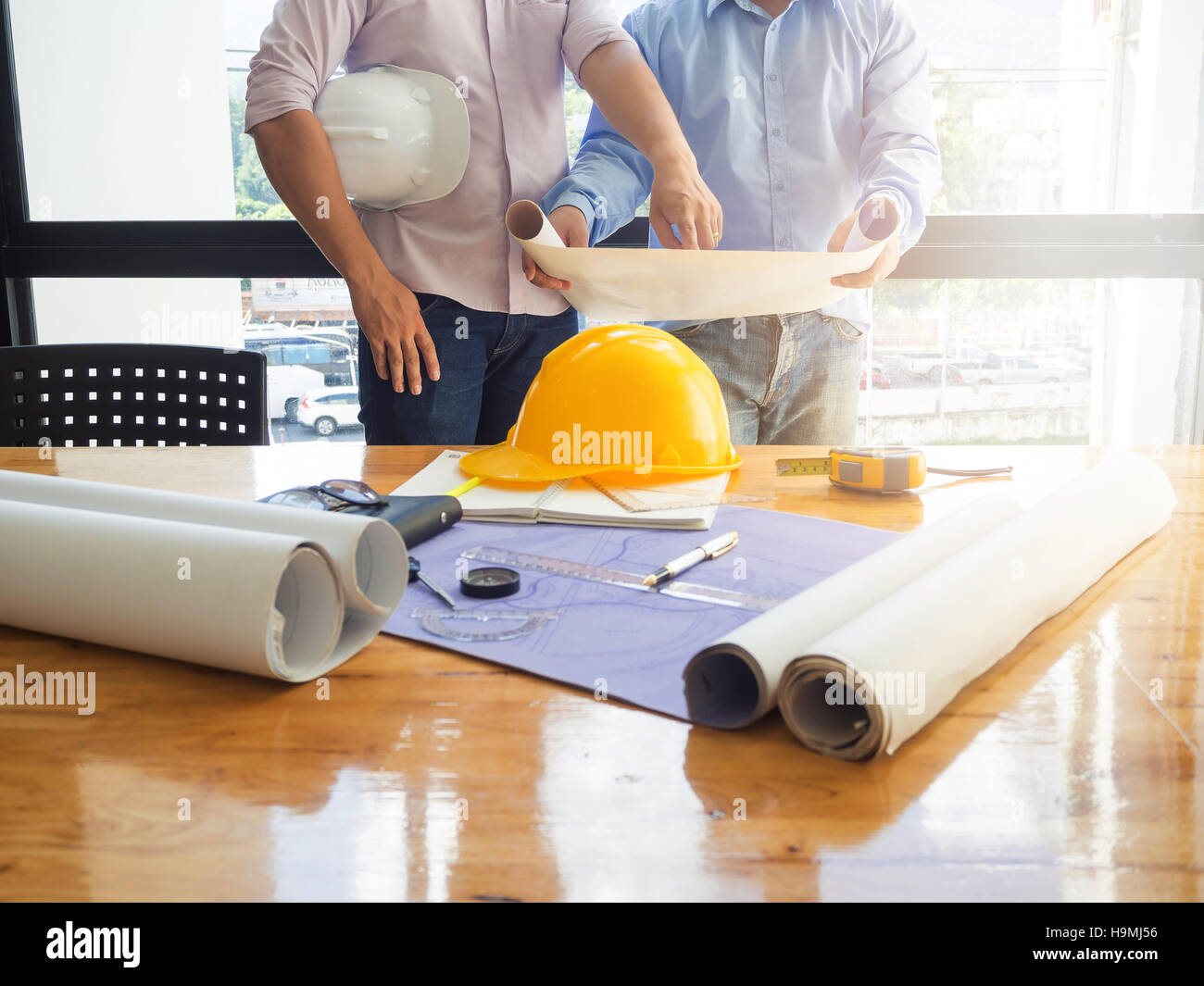 Architect concept, Architects working with blueprints in the office ...