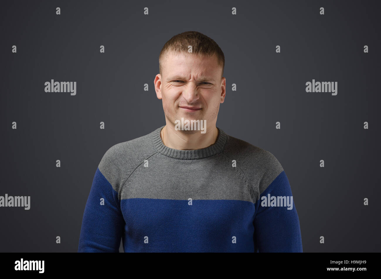 Portrait of a young man who is dissatisfied with something. Emotional ...