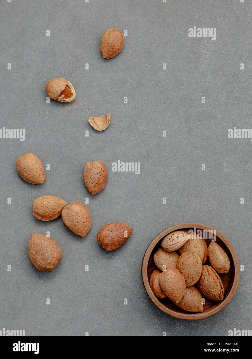Almonds kernels and whole almonds on concrete background. Whole Stock ...