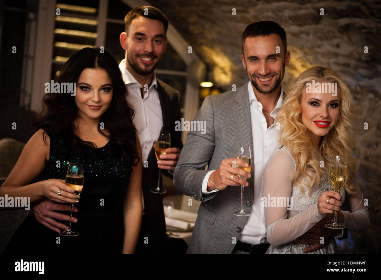 Four friends celebrating Stock Photo - Alamy