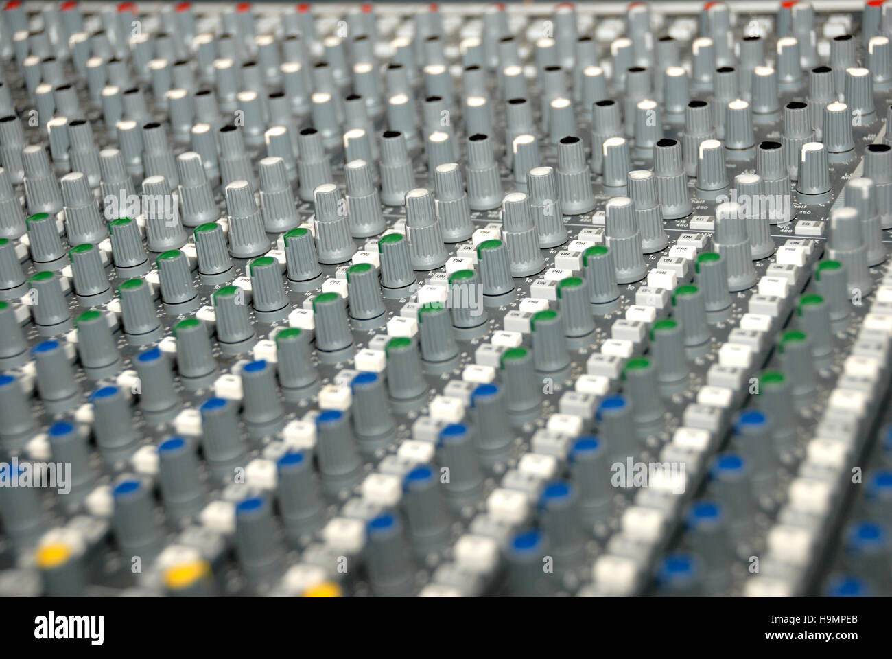 Audio mixing console in a recording studio. Faders and knobs of a sound ...