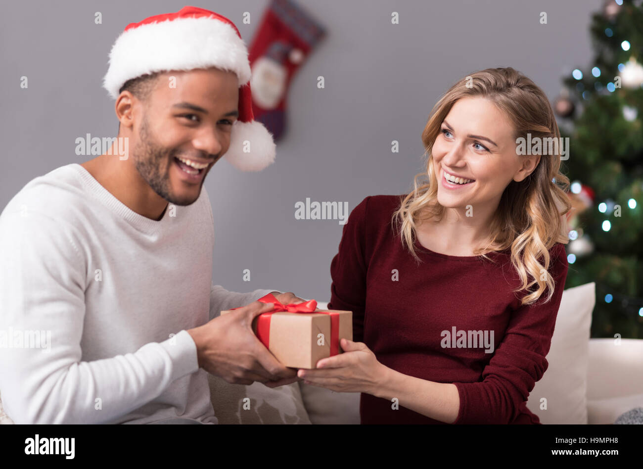 Happy charming woman giving a present Stock Photo - Alamy
