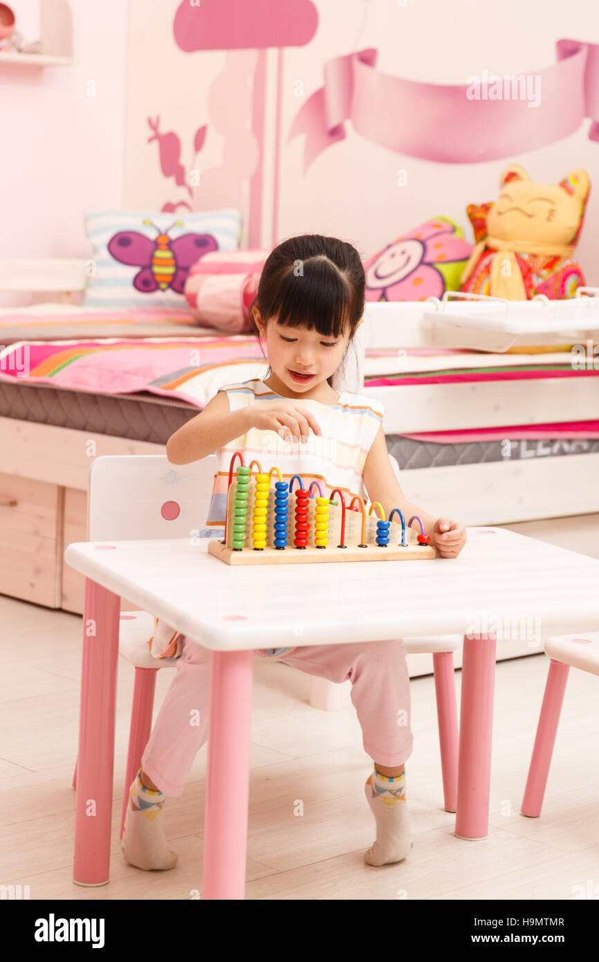 Cute little girl playing games Stock Photo - Alamy