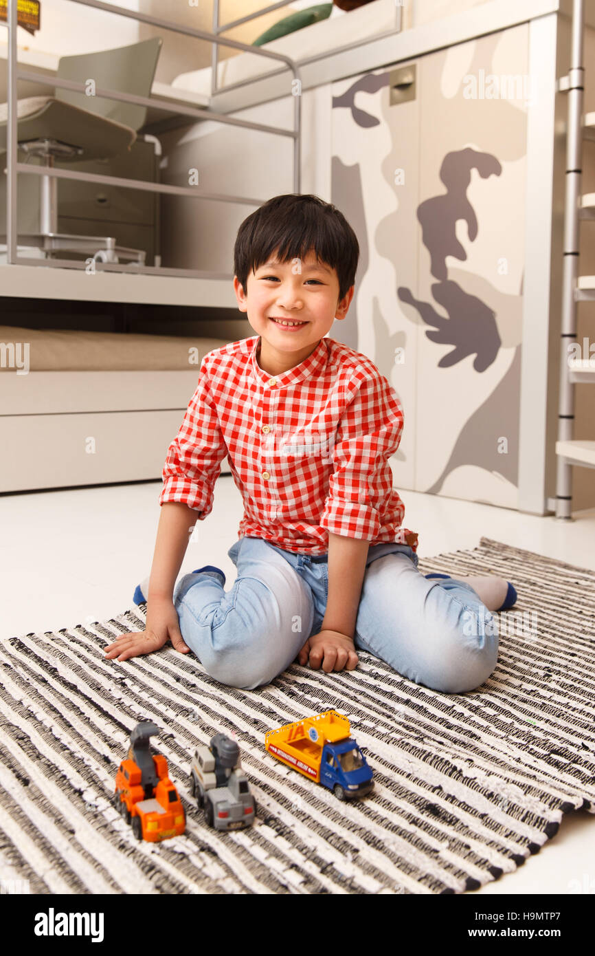 The little boy was playing on the carpet Stock Photo - Alamy