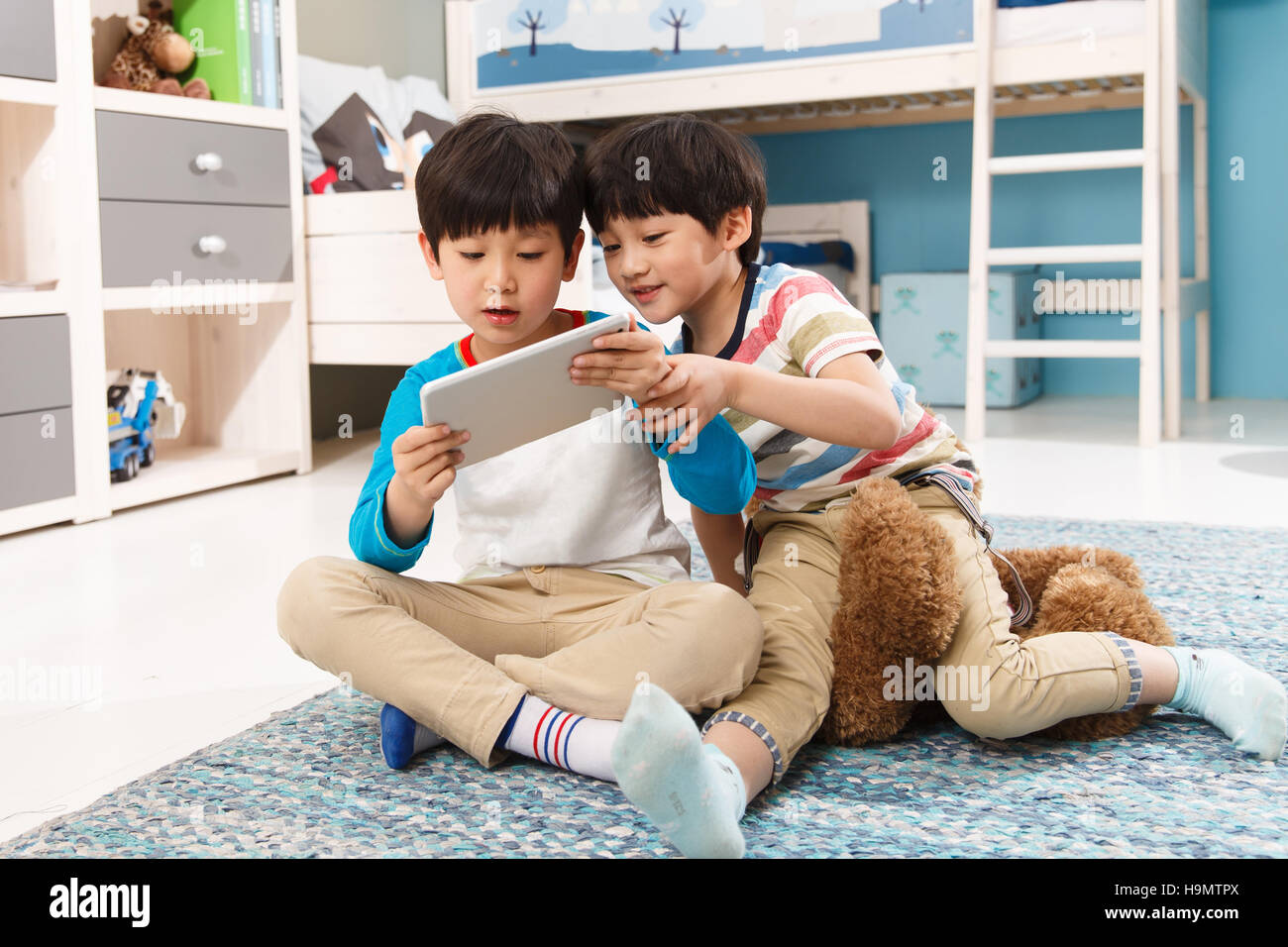 Two boys in the use of tablet PCs Stock Photo - Alamy