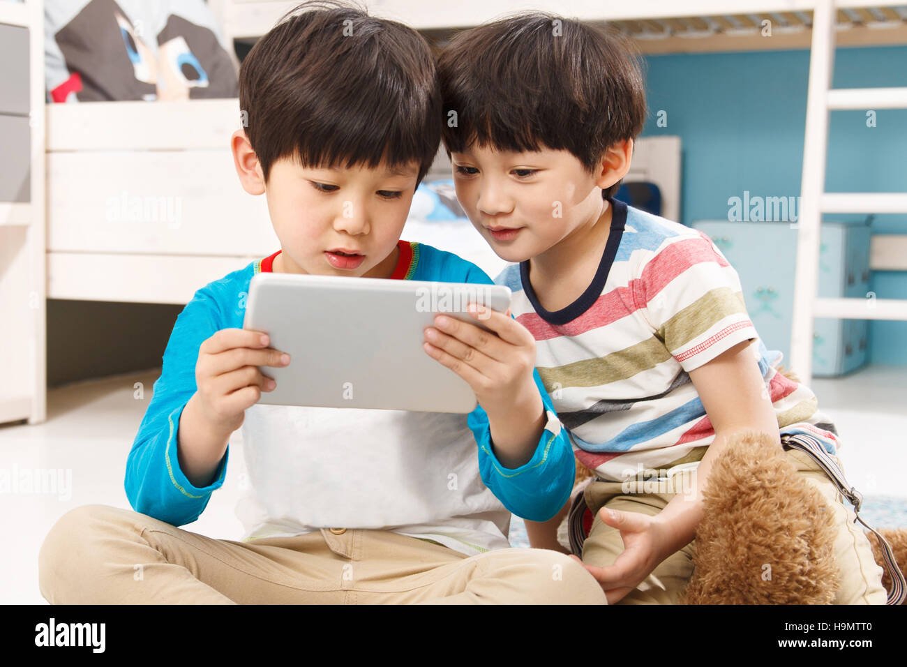 Two boys in the use of tablet PCs Stock Photo - Alamy