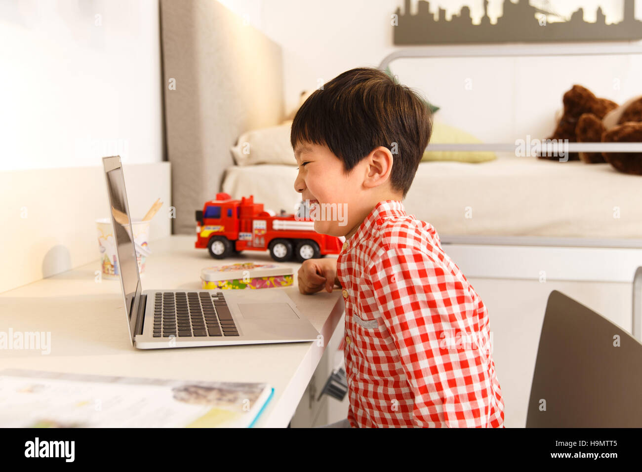 Cute little boy using a laptop Stock Photo - Alamy