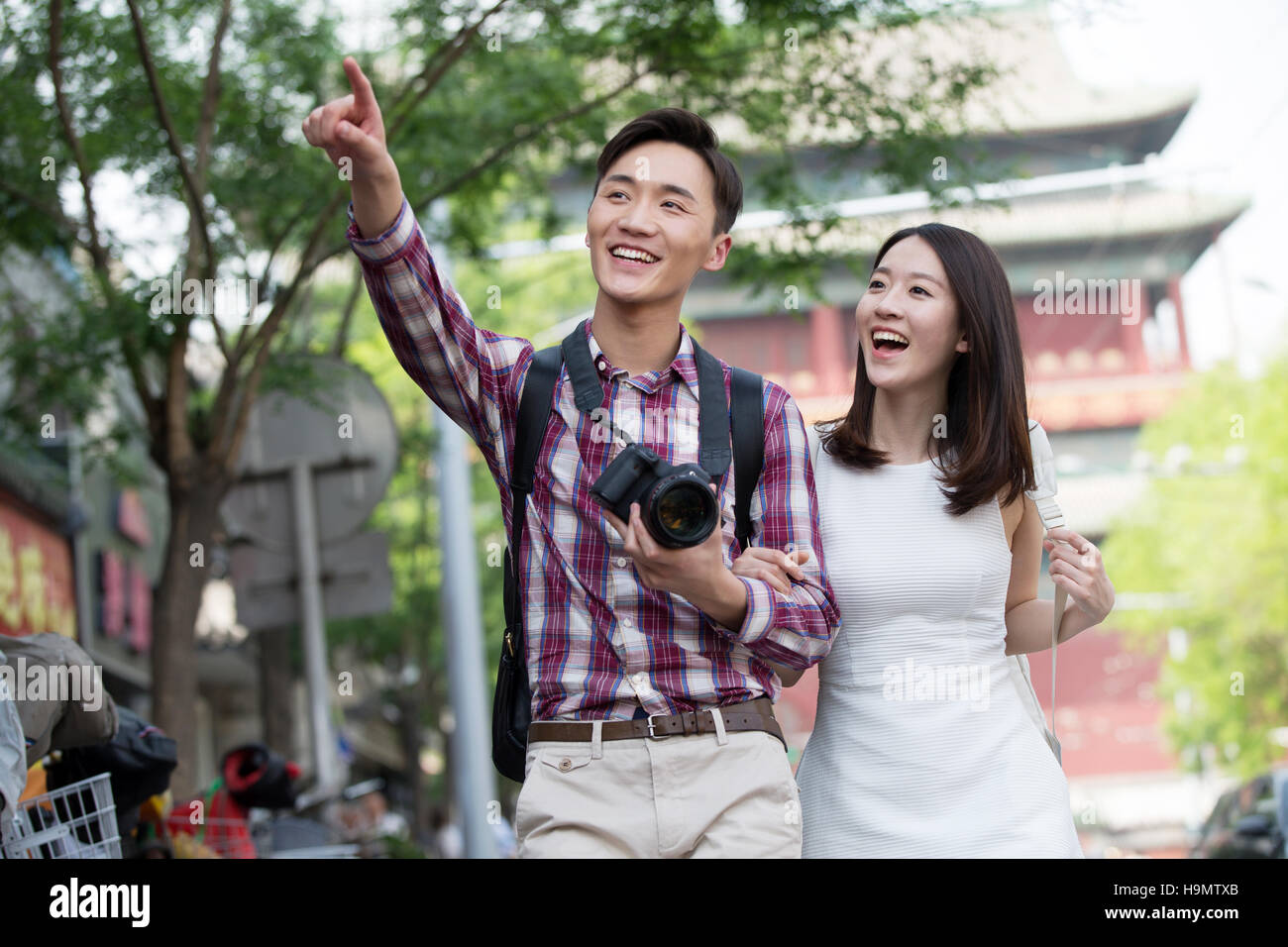 Young asian couple pointing camera hi-res stock photography and images ...