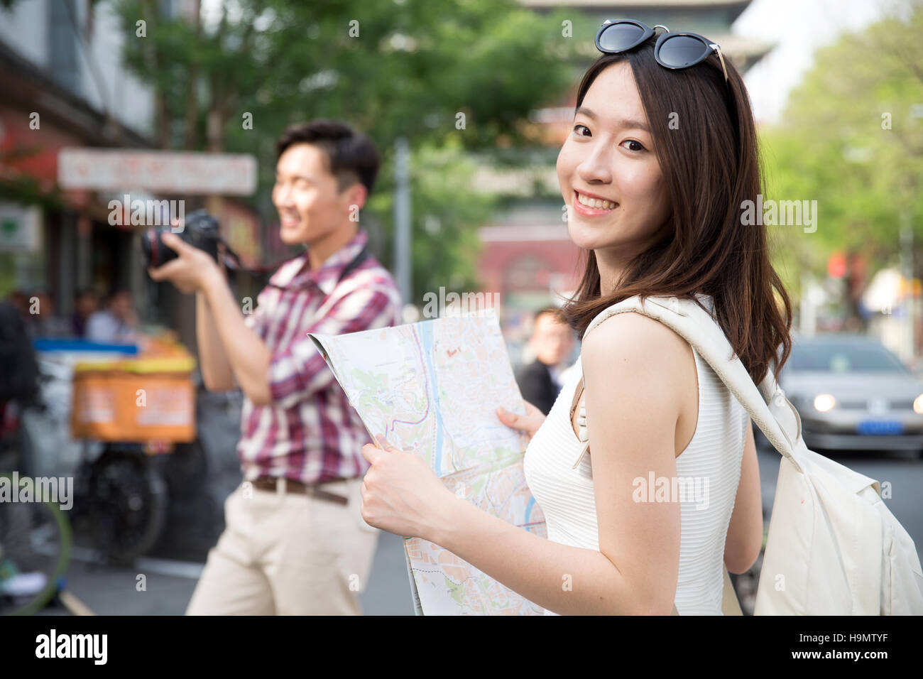 Young women travel with maps Stock Photo - Alamy