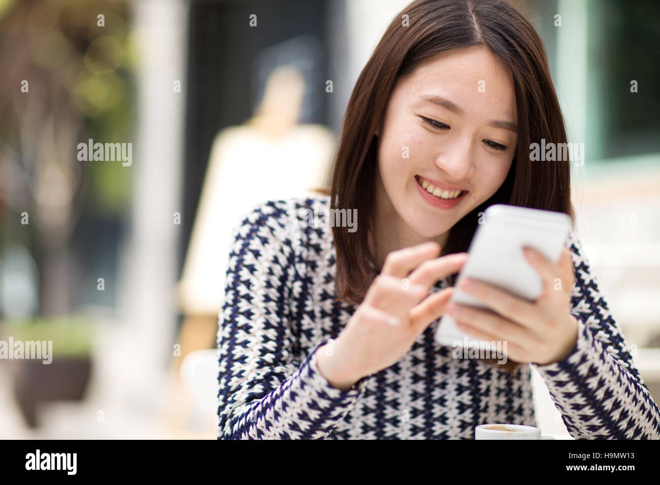 Young girl watching mobile phone Stock Photo - Alamy