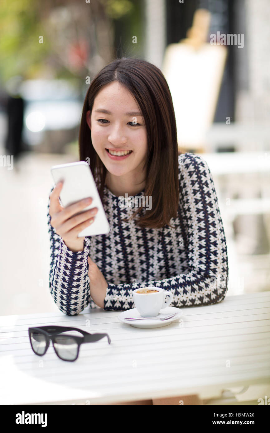 Young girl watching mobile phone Stock Photo - Alamy