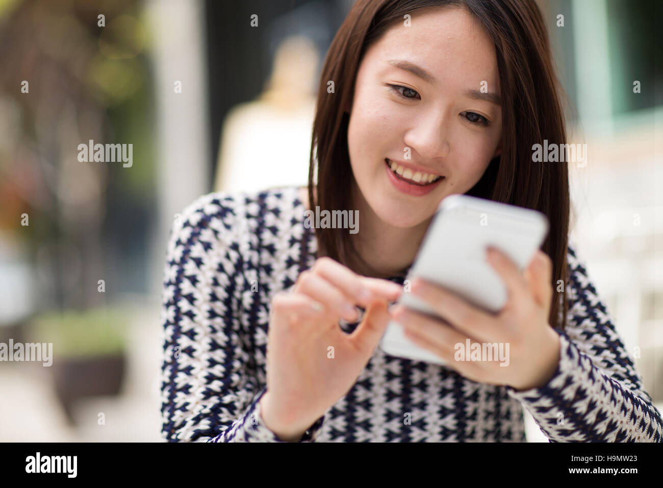 Young girl watching mobile phone Stock Photo - Alamy