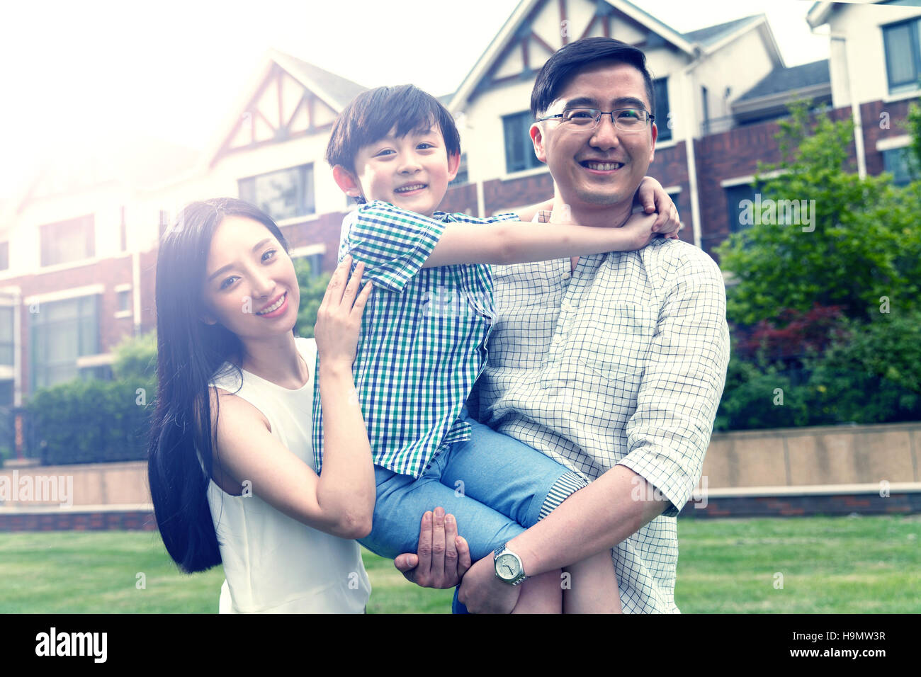 A happy family of three Stock Photo - Alamy