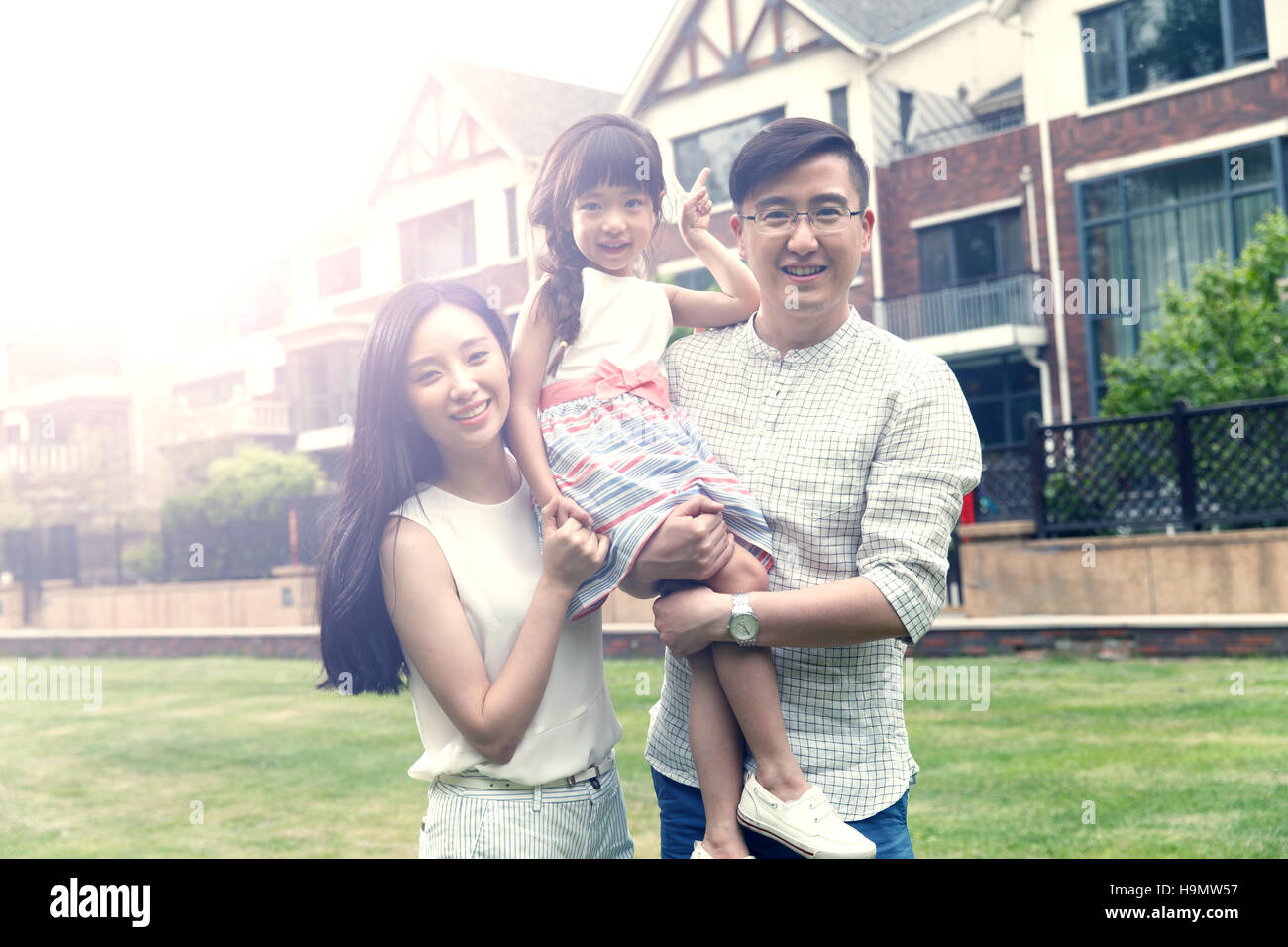 A happy family of three Stock Photo - Alamy