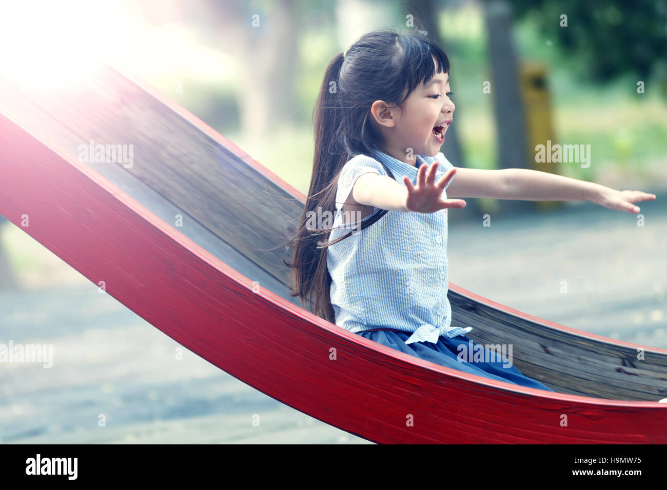 The little girl slide Stock Photo - Alamy