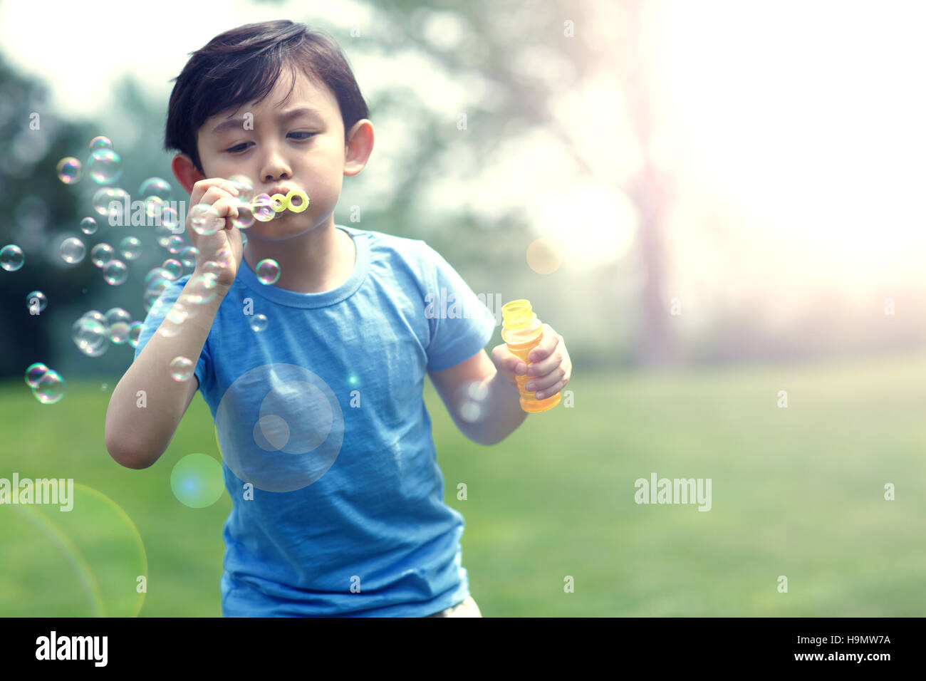 Little boy blowing bubbles Stock Photo - Alamy