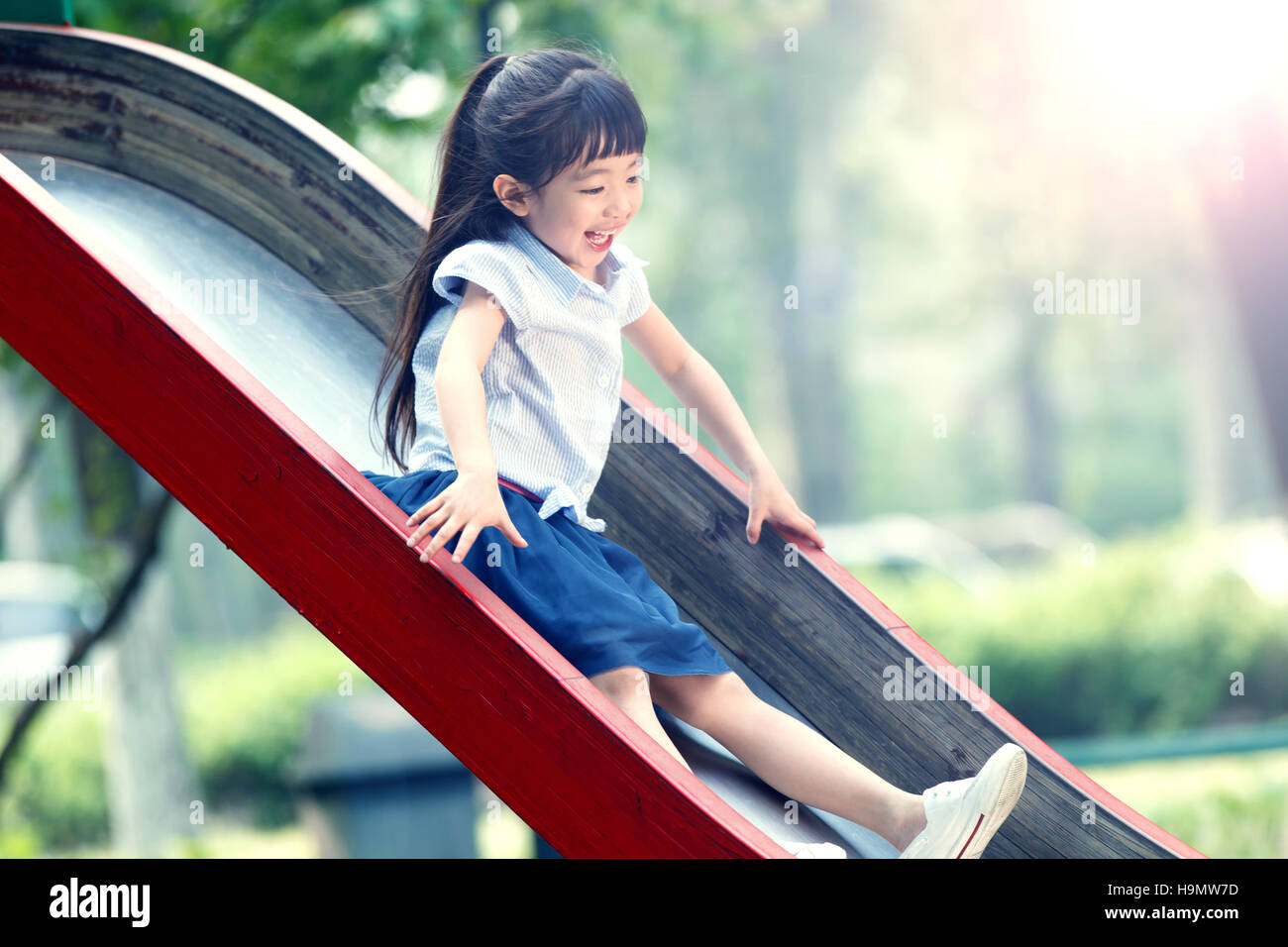 The little girl slide Stock Photo - Alamy