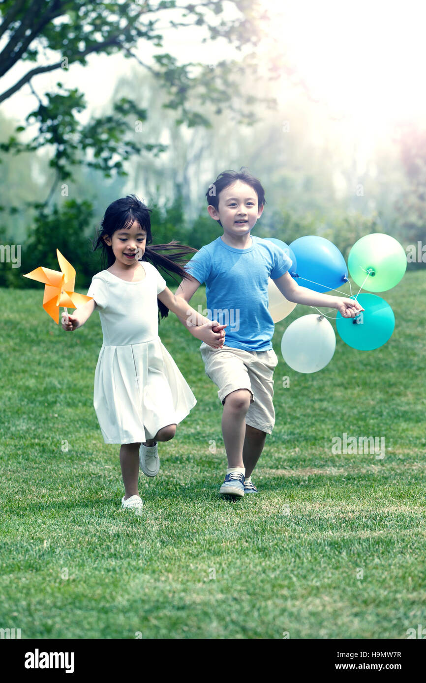 Happy children are playing on the grass Stock Photo - Alamy