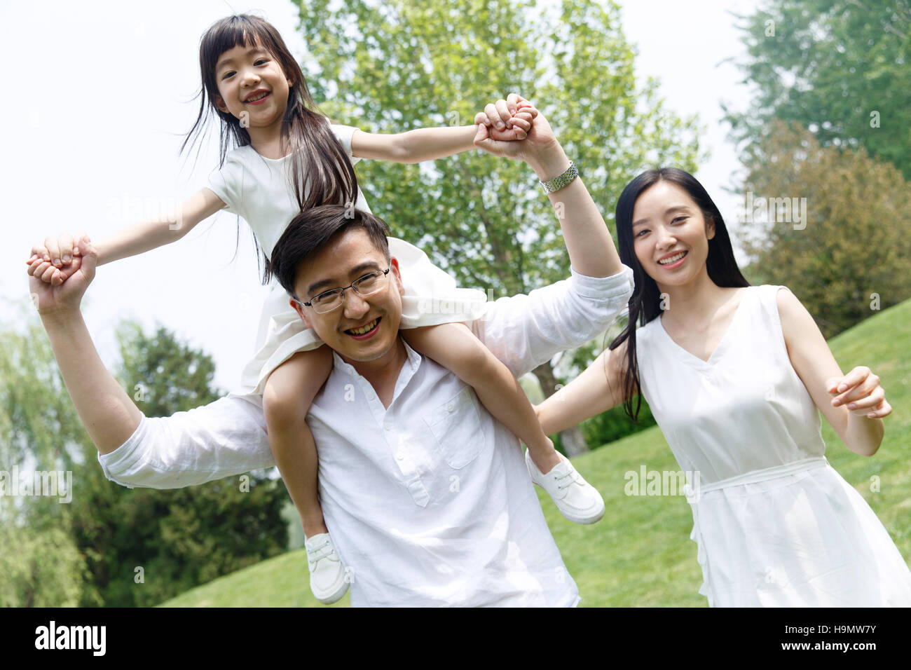 A happy family of three Stock Photo - Alamy