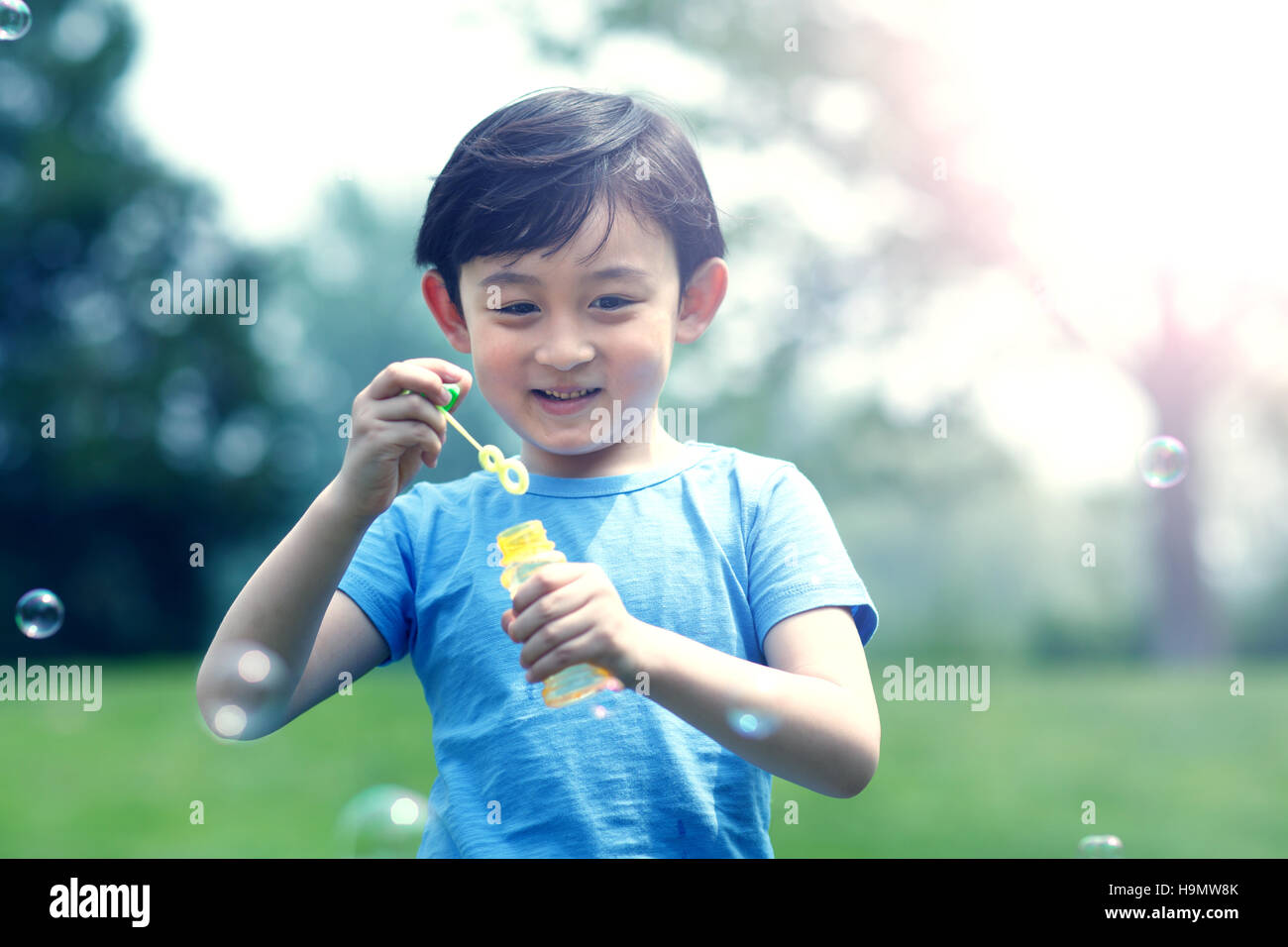 Little boy blowing bubbles Stock Photo - Alamy