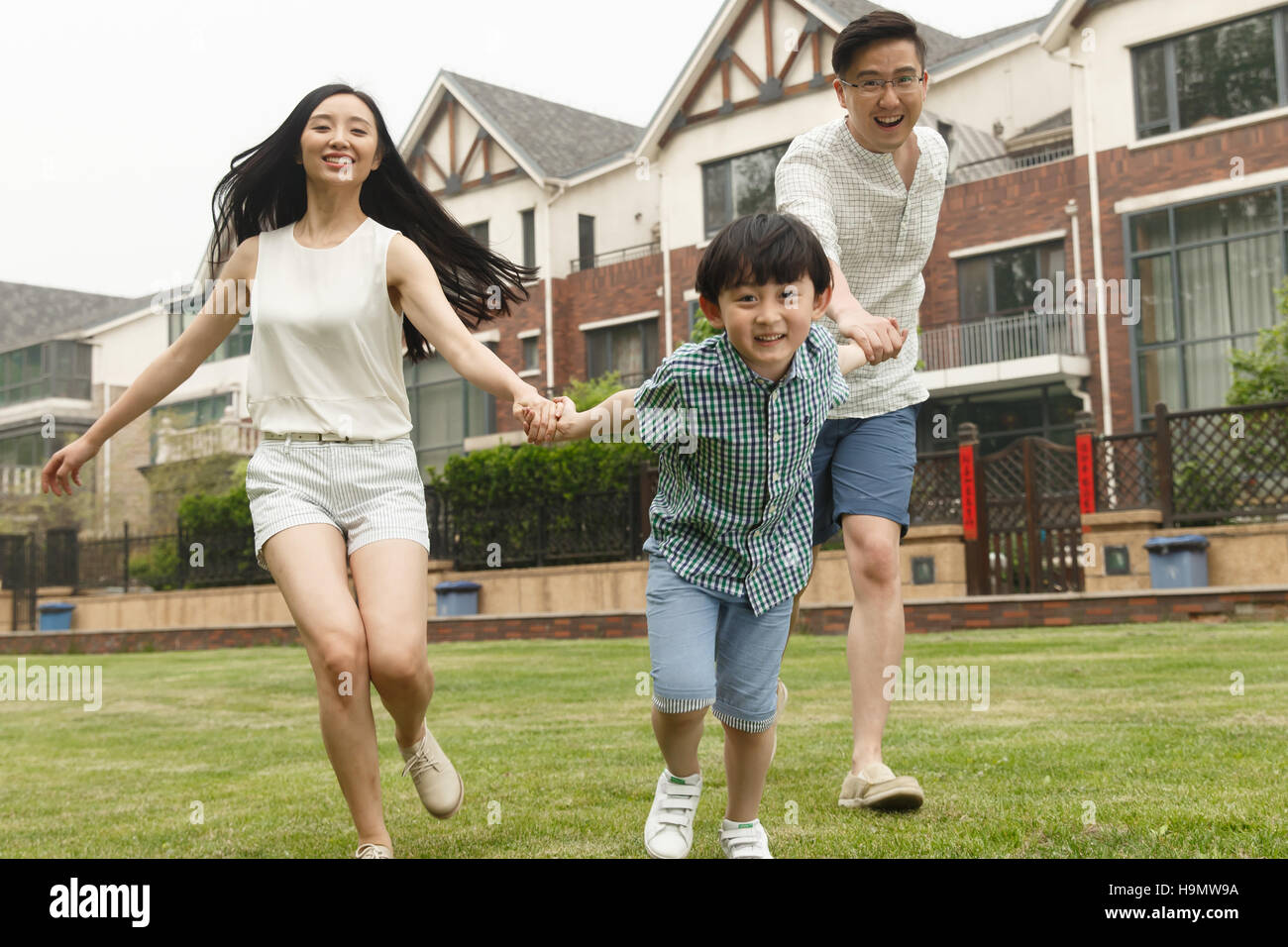 A happy family of three Stock Photo - Alamy