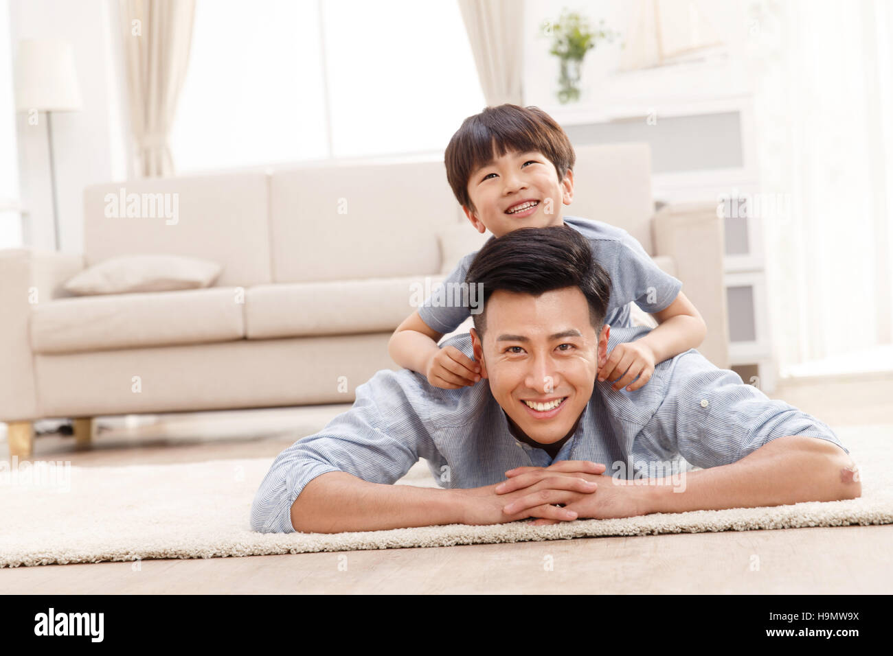 Happy father and son in the living room to play Stock Photo - Alamy
