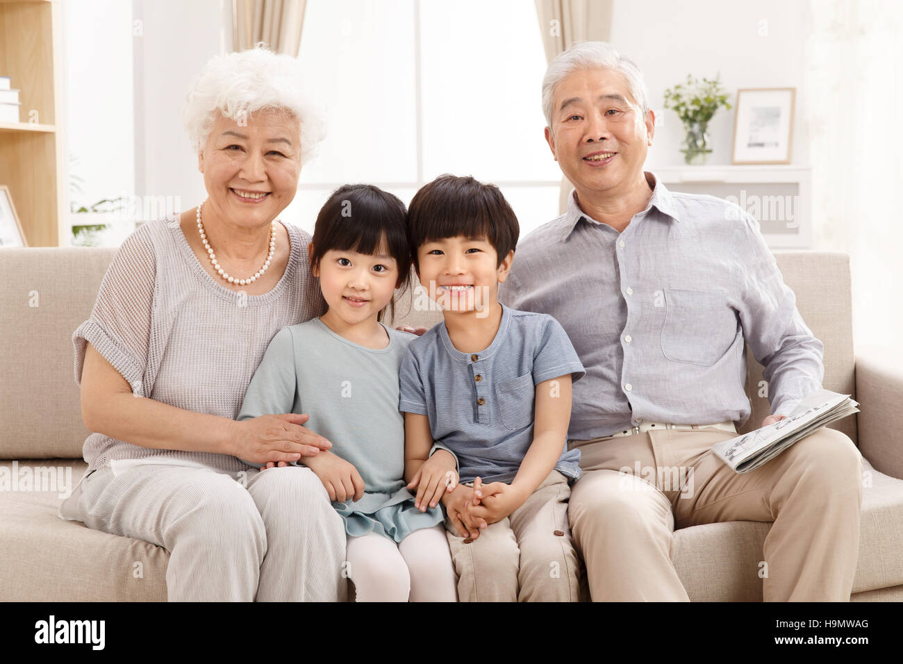 Happy family photo in the living room Stock Photo - Alamy
