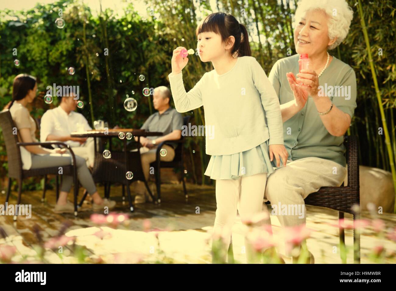 Happy family in the yard Stock Photo - Alamy