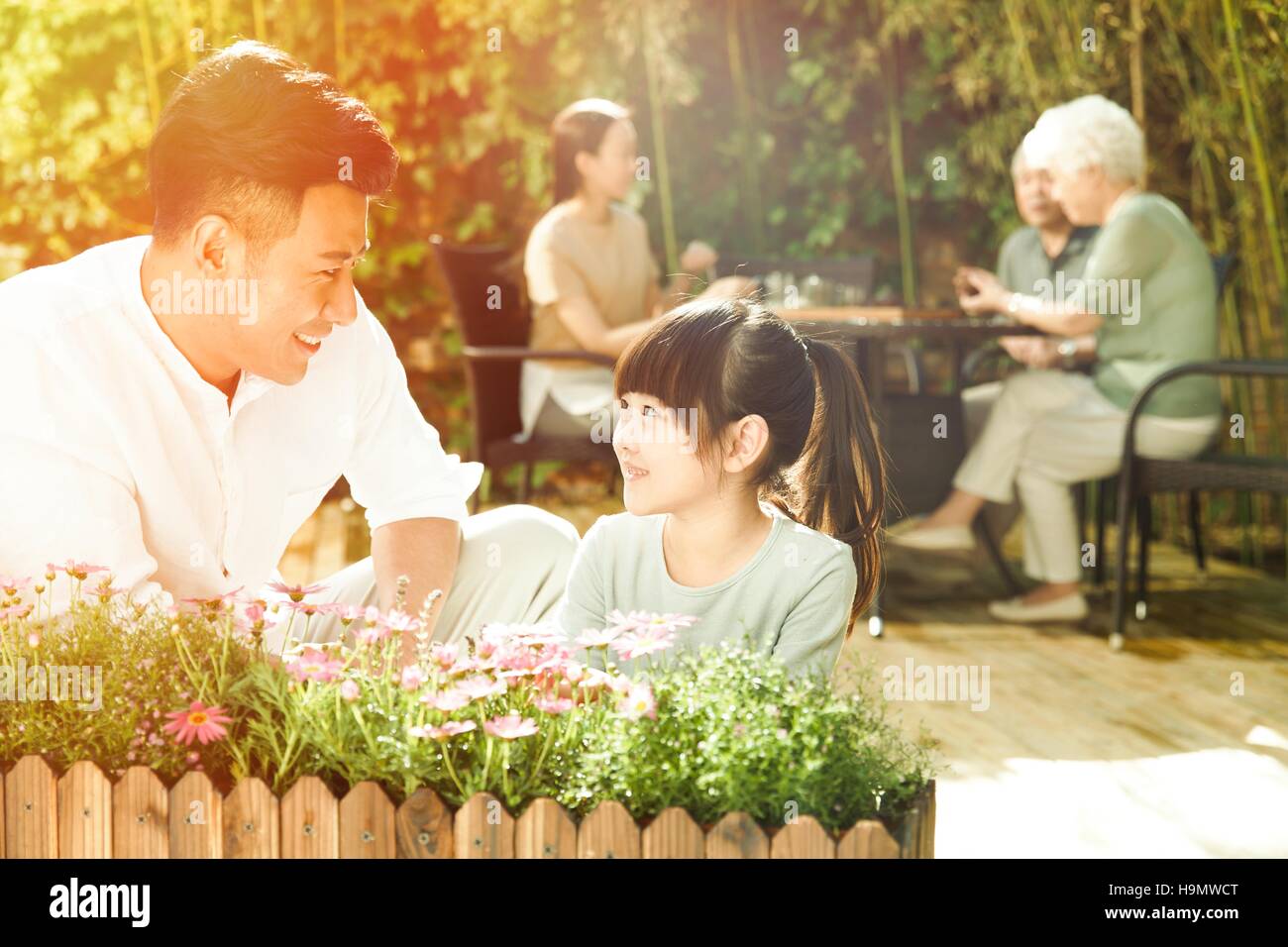 Happy family in the yard Stock Photo - Alamy
