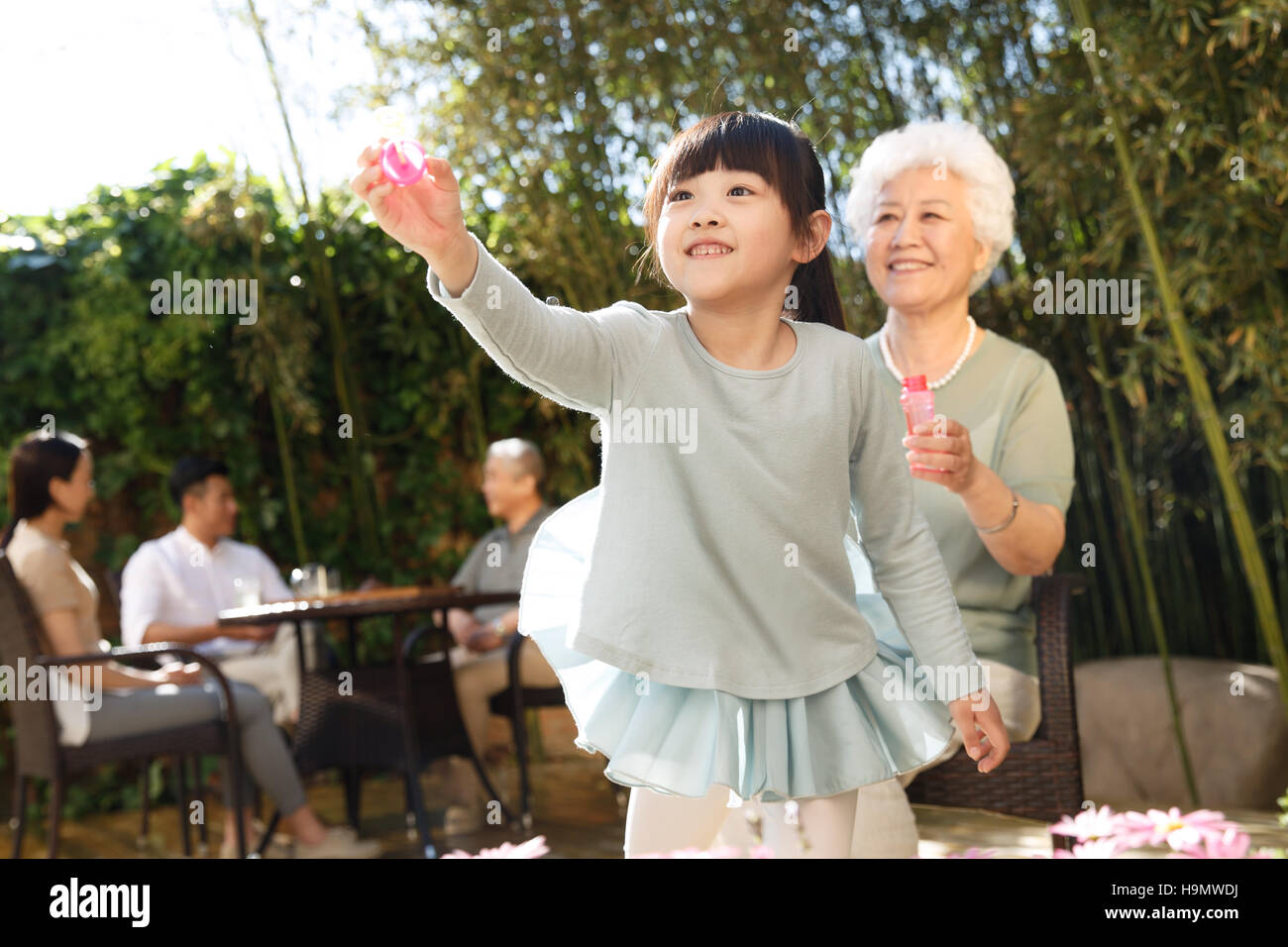 Happy family in the yard Stock Photo - Alamy