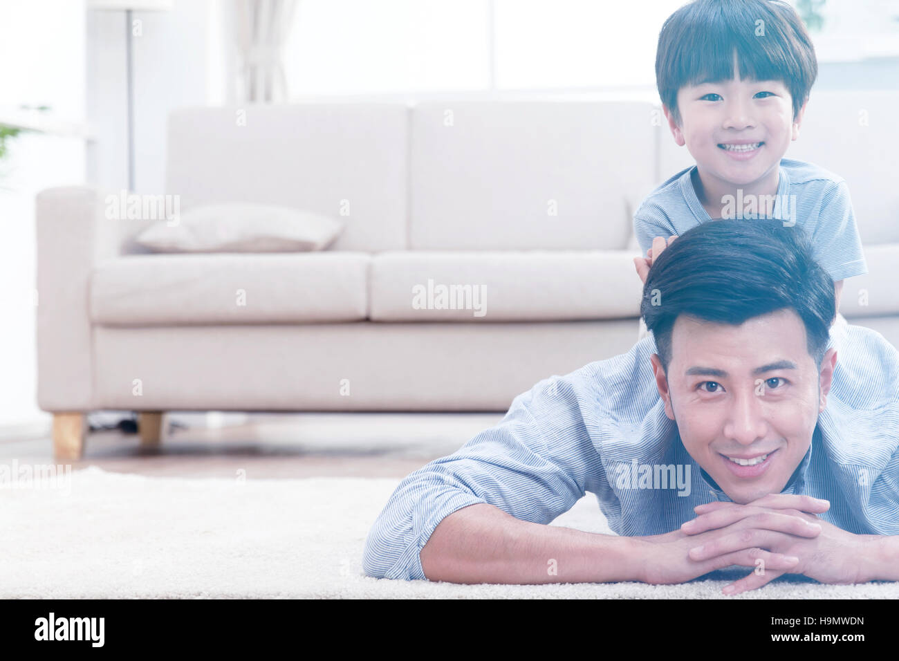 Happy father and son in the living room to play Stock Photo - Alamy
