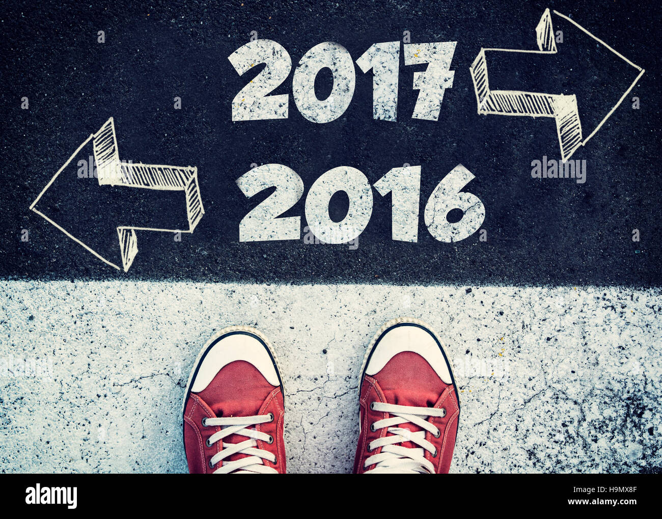 Student standing above the sign 2016 or 2017 dilemma Stock Photo - Alamy