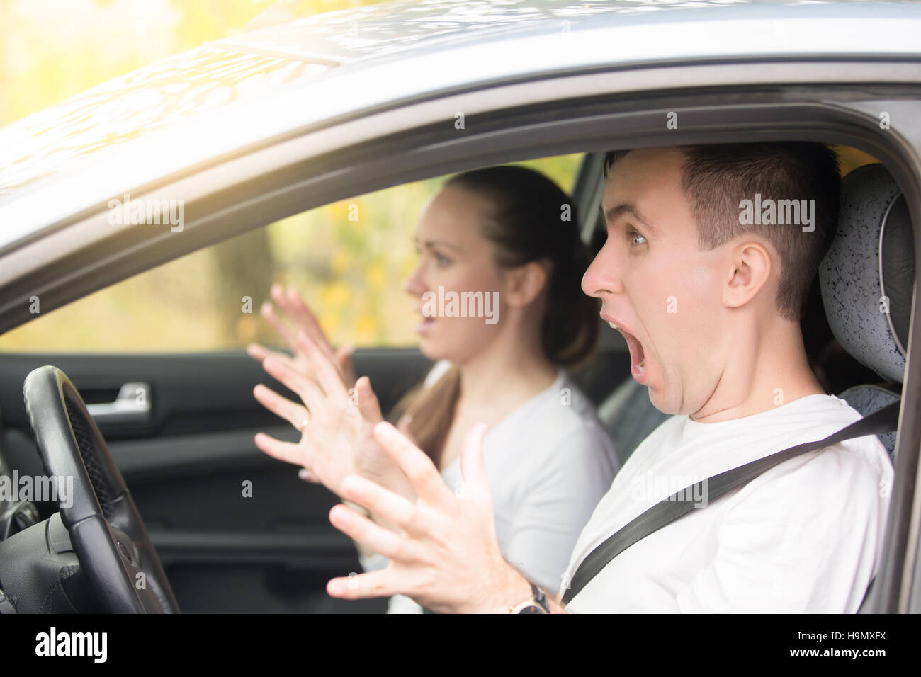 Young scared man driver and a woman passenger Stock Photo - Alamy