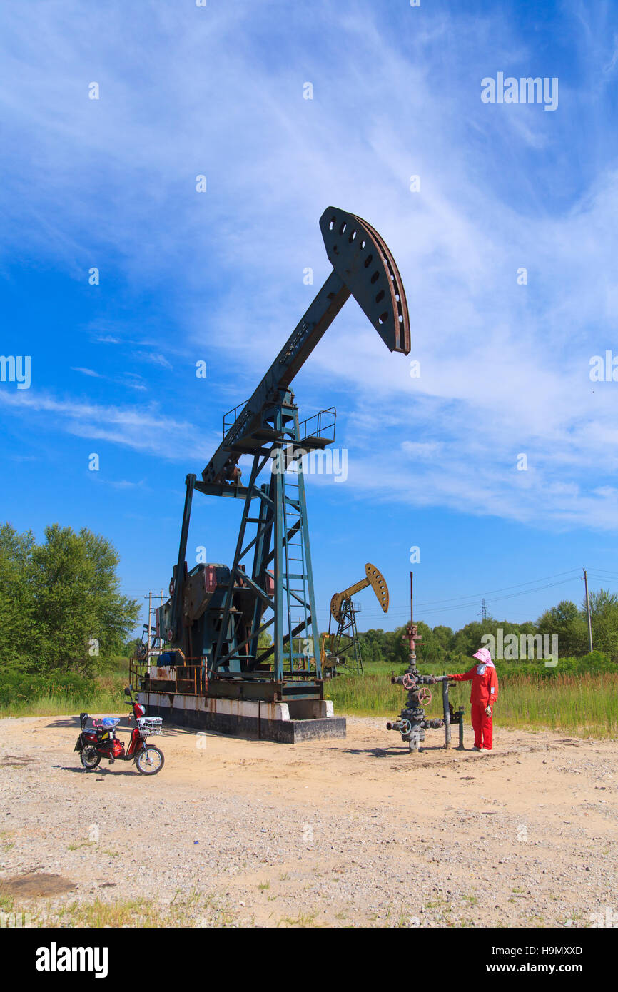 Pumping unit and woman worker Stock Photo - Alamy