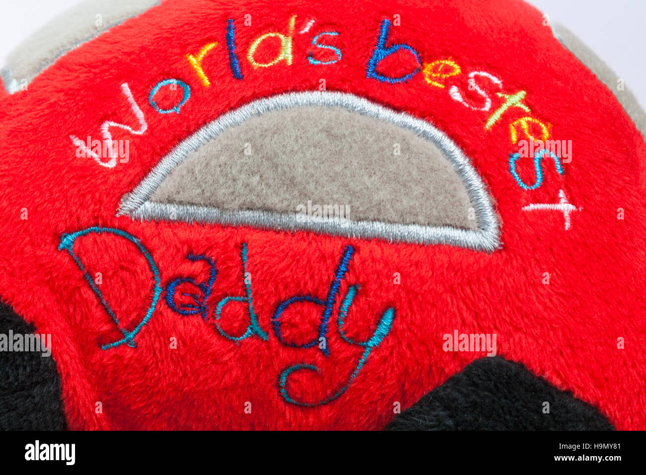 Worlds bestest Daddy - detail on red car soft cuddly toy set on white ...