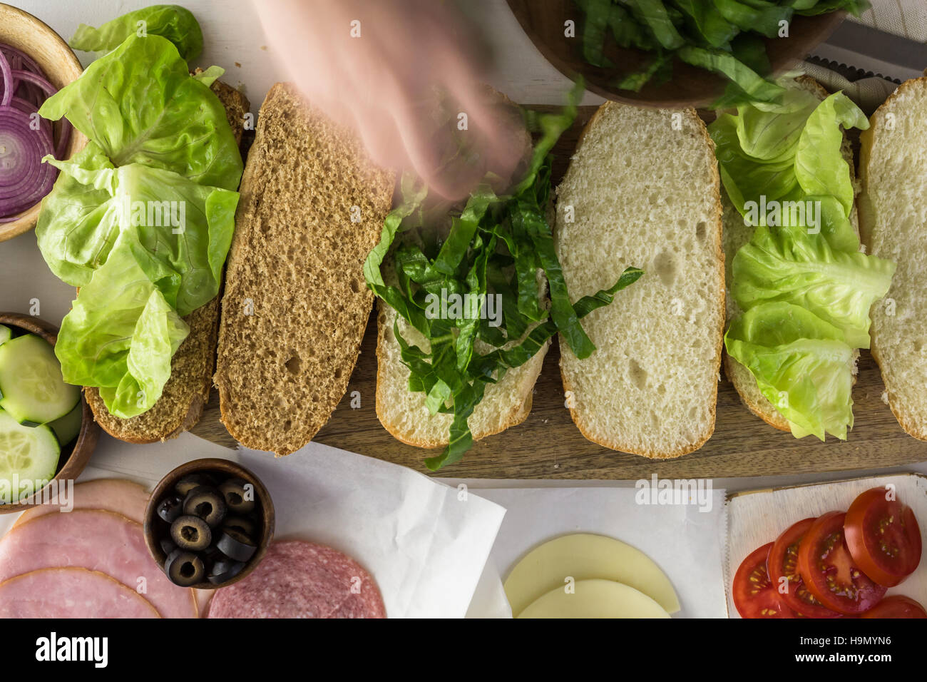 Step by step. Fresh sub sandwich on white and wheat hoagies Stock Photo ...