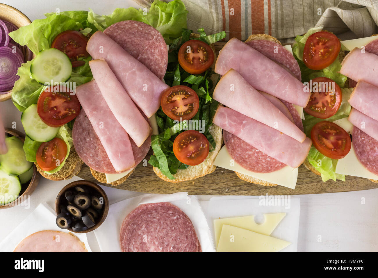 Step by step. Fresh sub sandwich on white and wheat hoagies Stock Photo ...