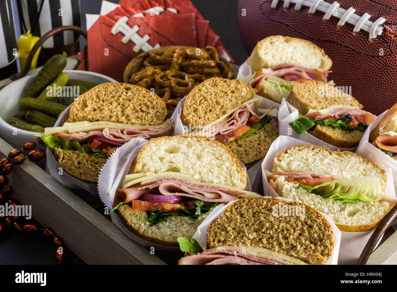 Game day football party table with sub sandwich and snacks Stock Photo ...