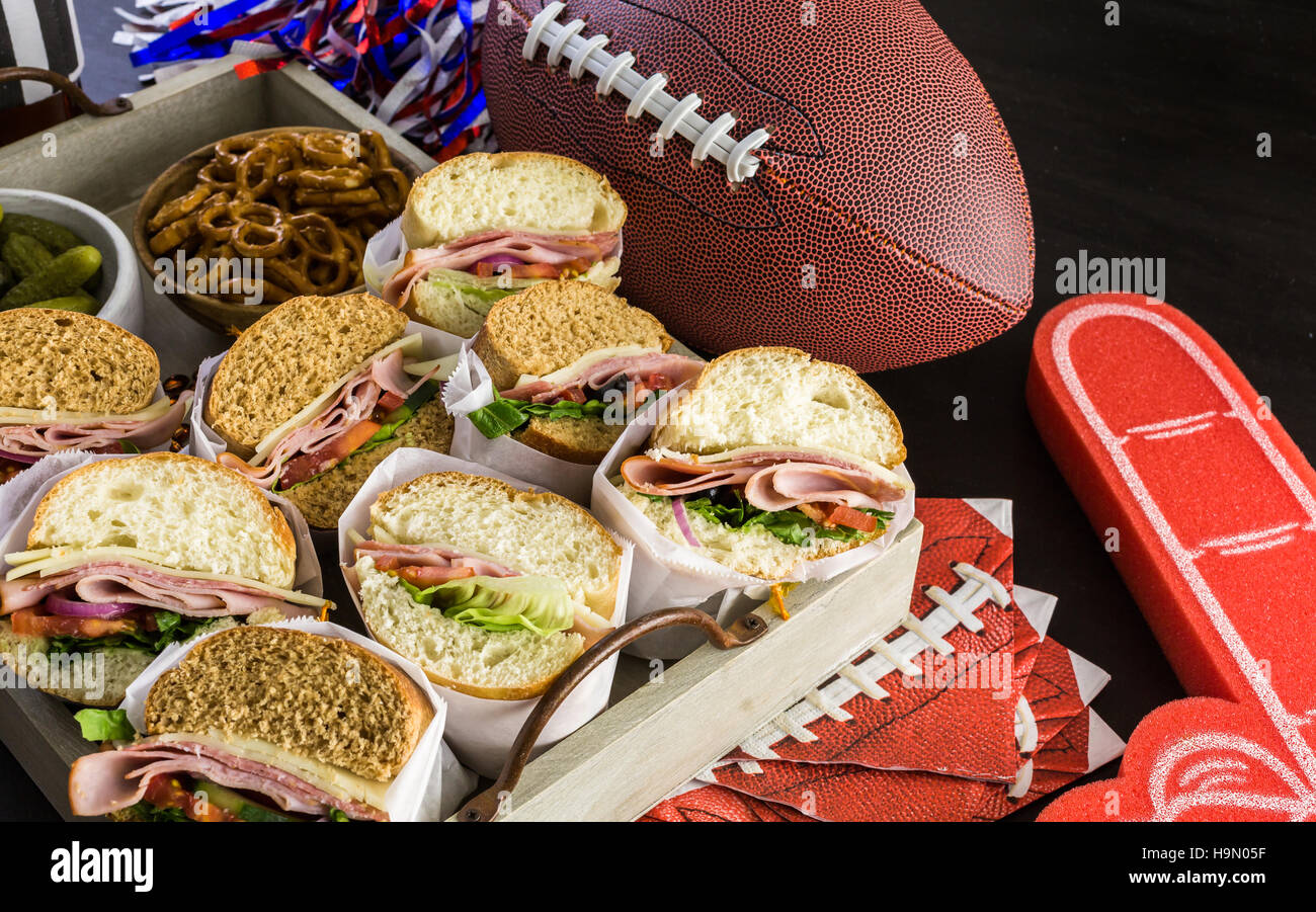 Game day football party table with sub sandwich and snacks Stock Photo ...