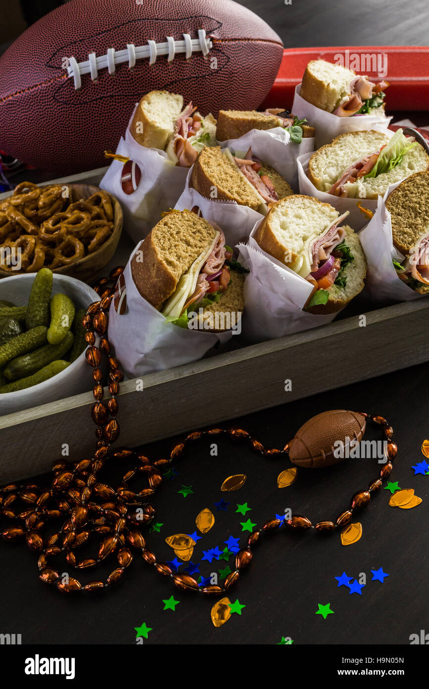 Game day football party table with sub sandwich and snacks Stock Photo ...