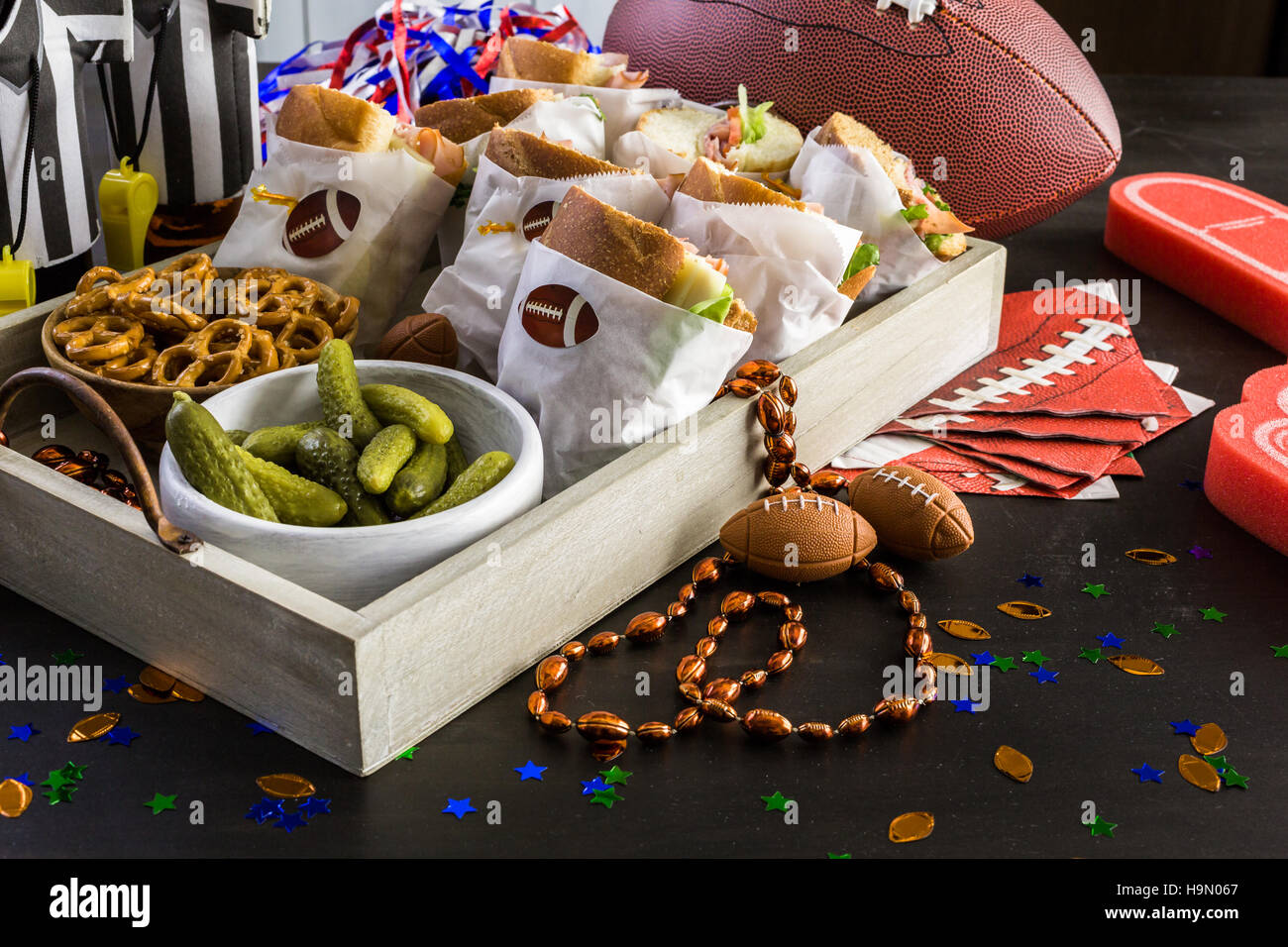 Game day football party table with sub sandwich and snacks Stock Photo ...