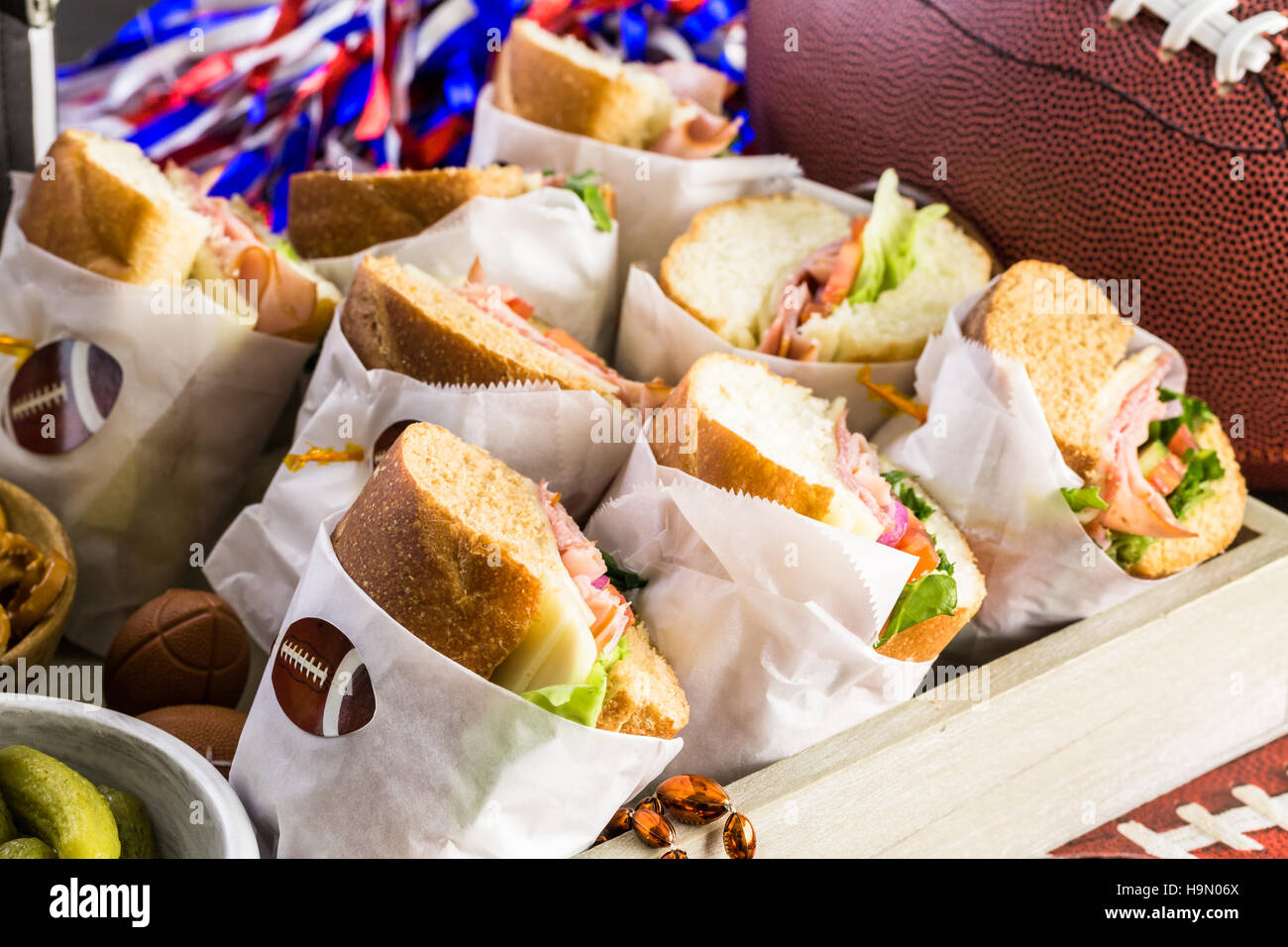 Game day football party table with sub sandwich and snacks Stock Photo ...