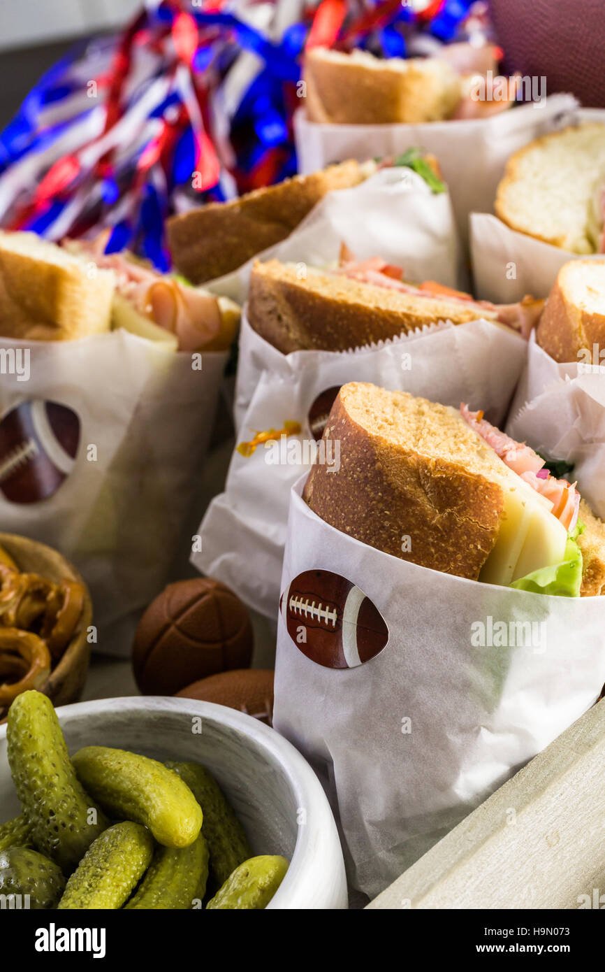 Game day football party table with sub sandwich and snacks Stock Photo ...