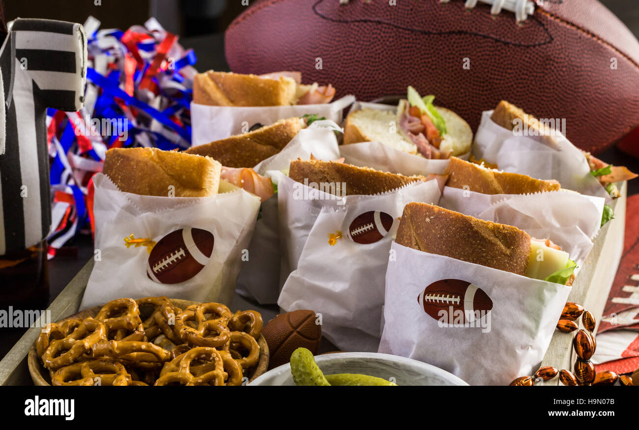 Game day football party table with sub sandwich and snacks Stock Photo ...