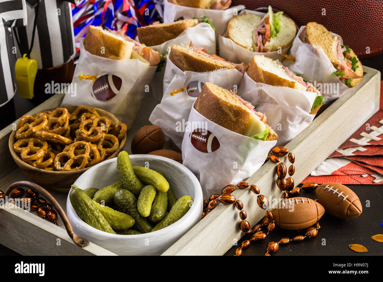 Game day football party table with sub sandwich and snacks Stock Photo ...